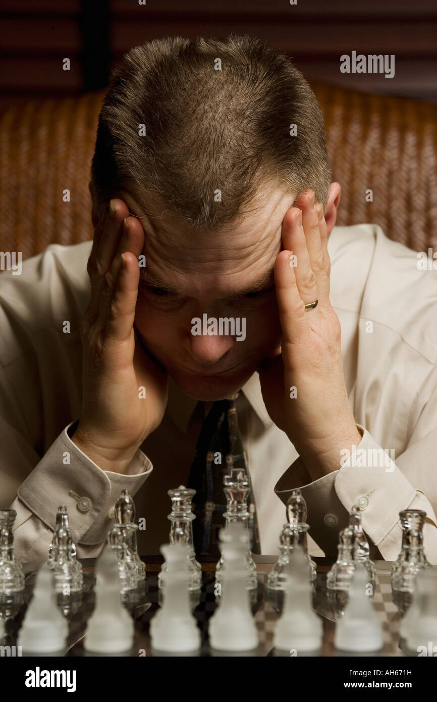 Man concentrating on chess game Stock Photo - Alamy