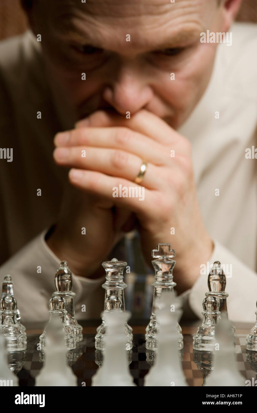 Man concentrating on chess game Stock Photo - Alamy