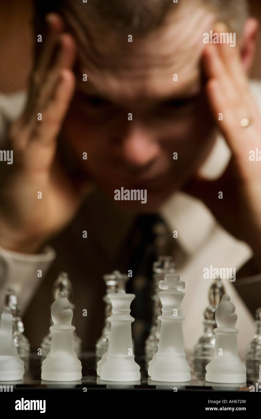 Man concentrating on chess game Stock Photo - Alamy