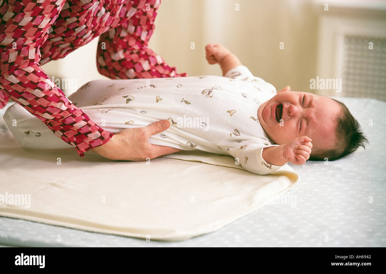 Mom changing baby Stock Photo - Alamy