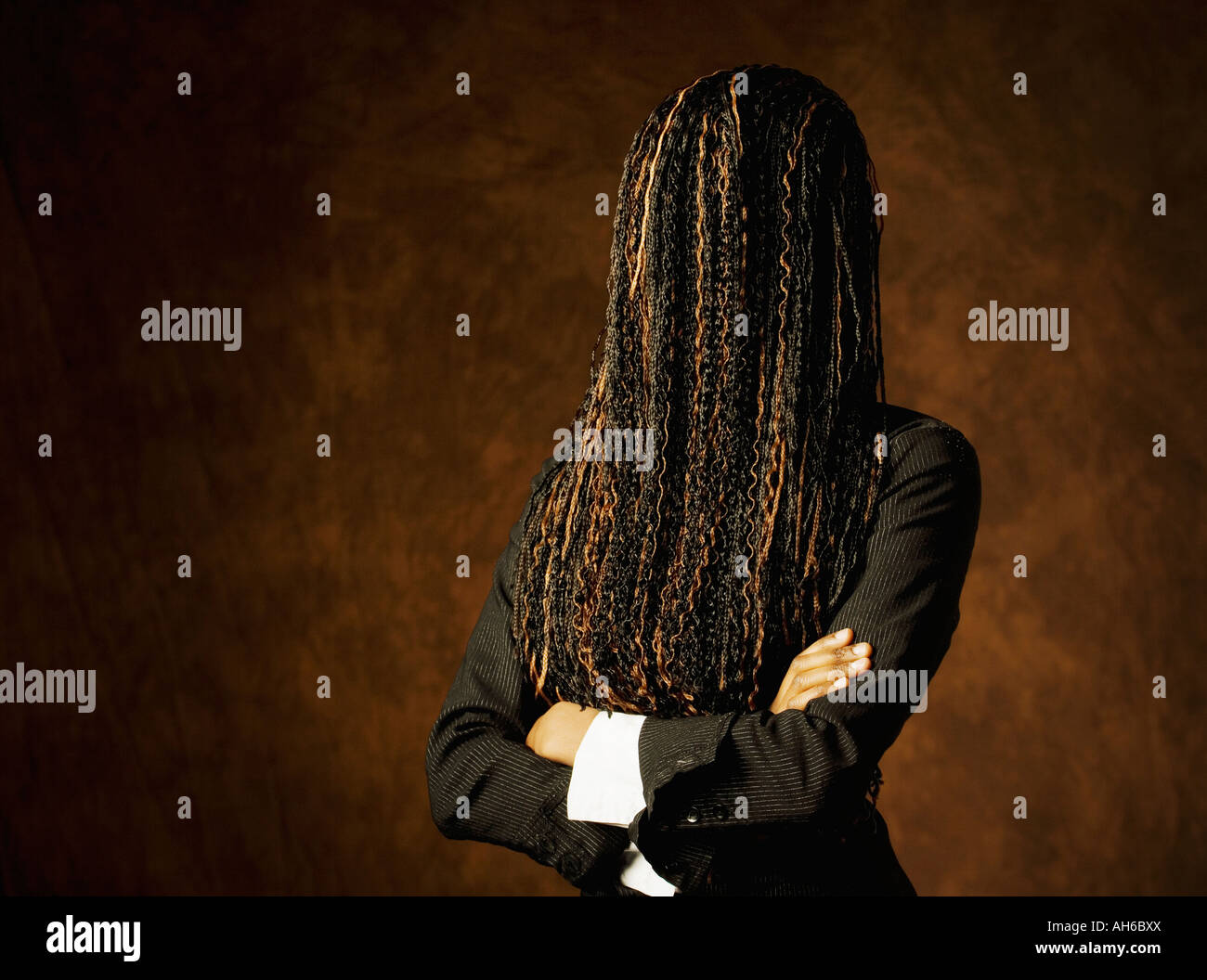 Woman with hair covering her face and arms crossed Stock Photo - Alamy