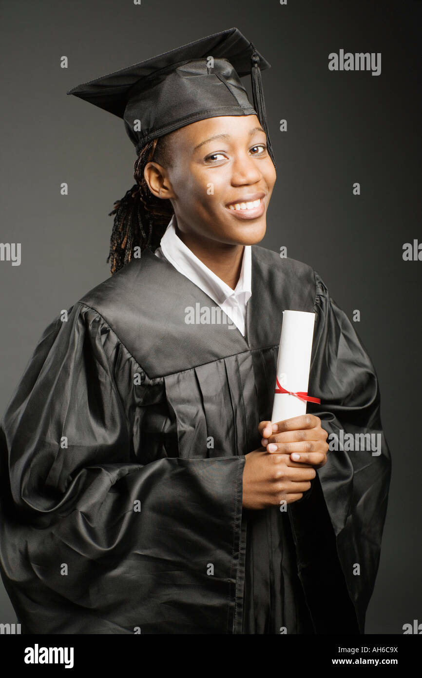 Young woman in cap and gown with diploma Stock Photo - Alamy