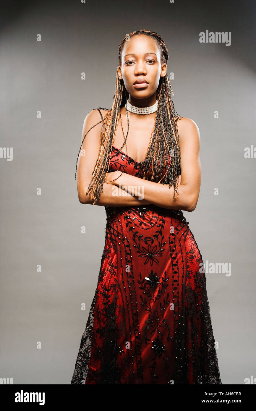 Young woman in formal gown with arms crossed Stock Photo - Alamy