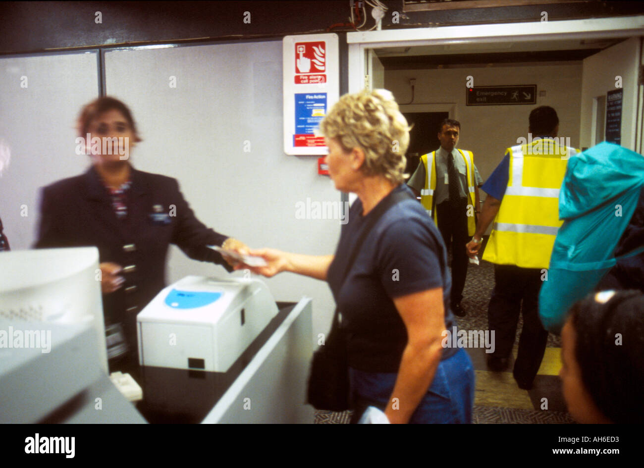 Final passport and boarding card check by ground staff at gate prior to ...