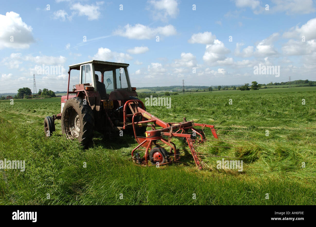 Tractor pulling thresher machinery in farmland Stock Photo - Alamy