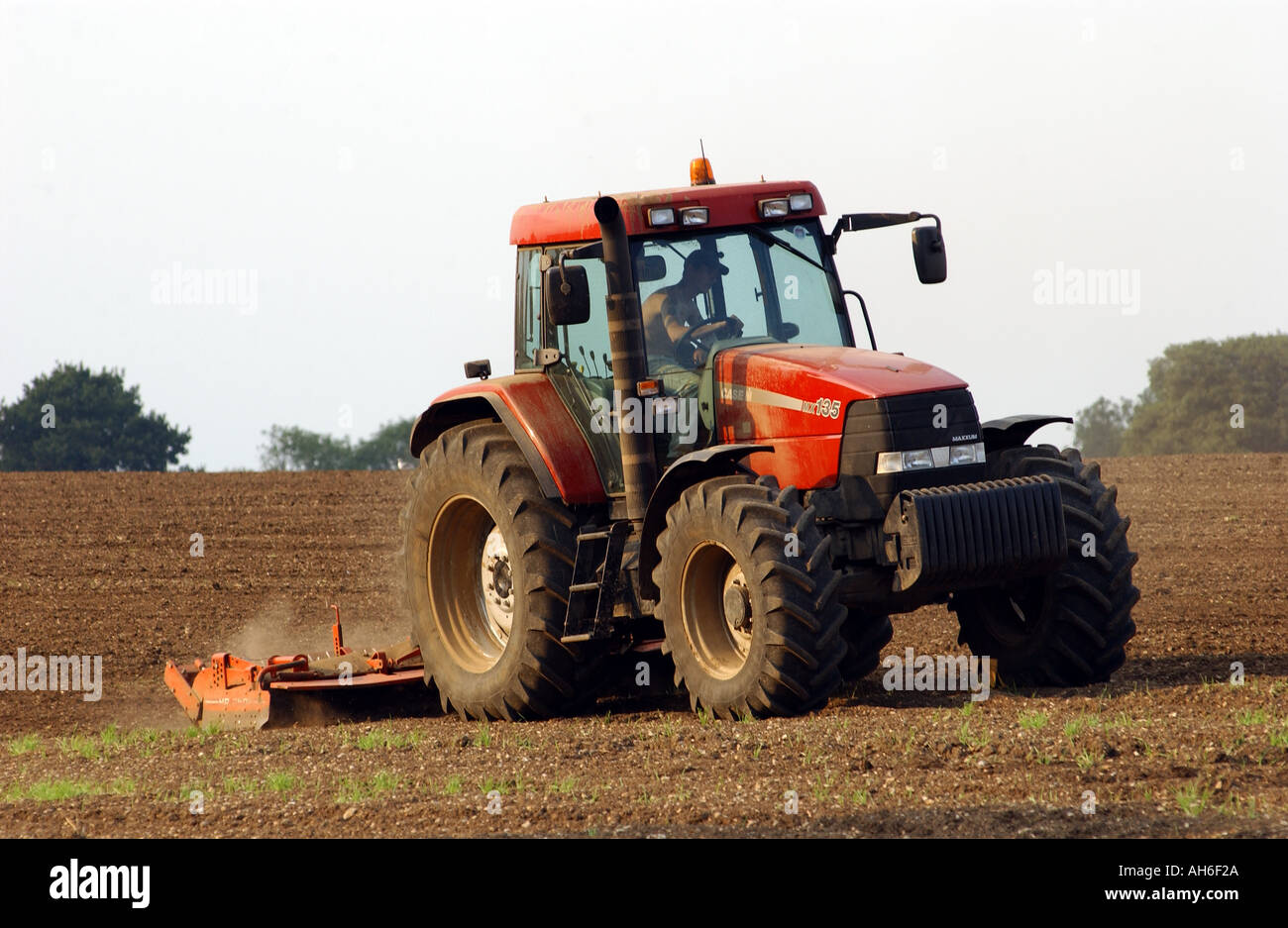Tractor breaking up the soil Stock Photo - Alamy