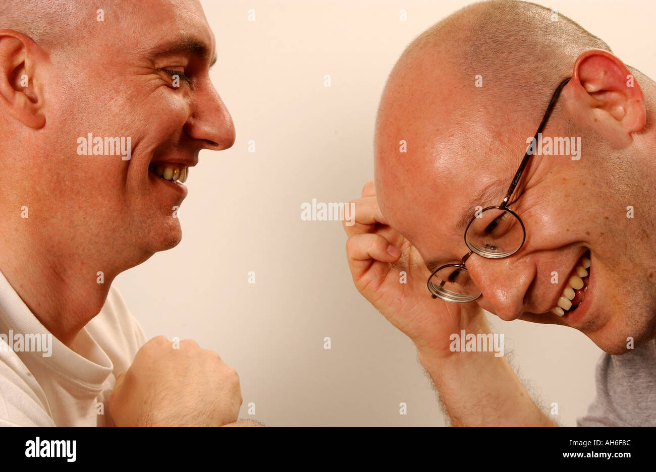 Two men laughing and chatting together Stock Photo - Alamy