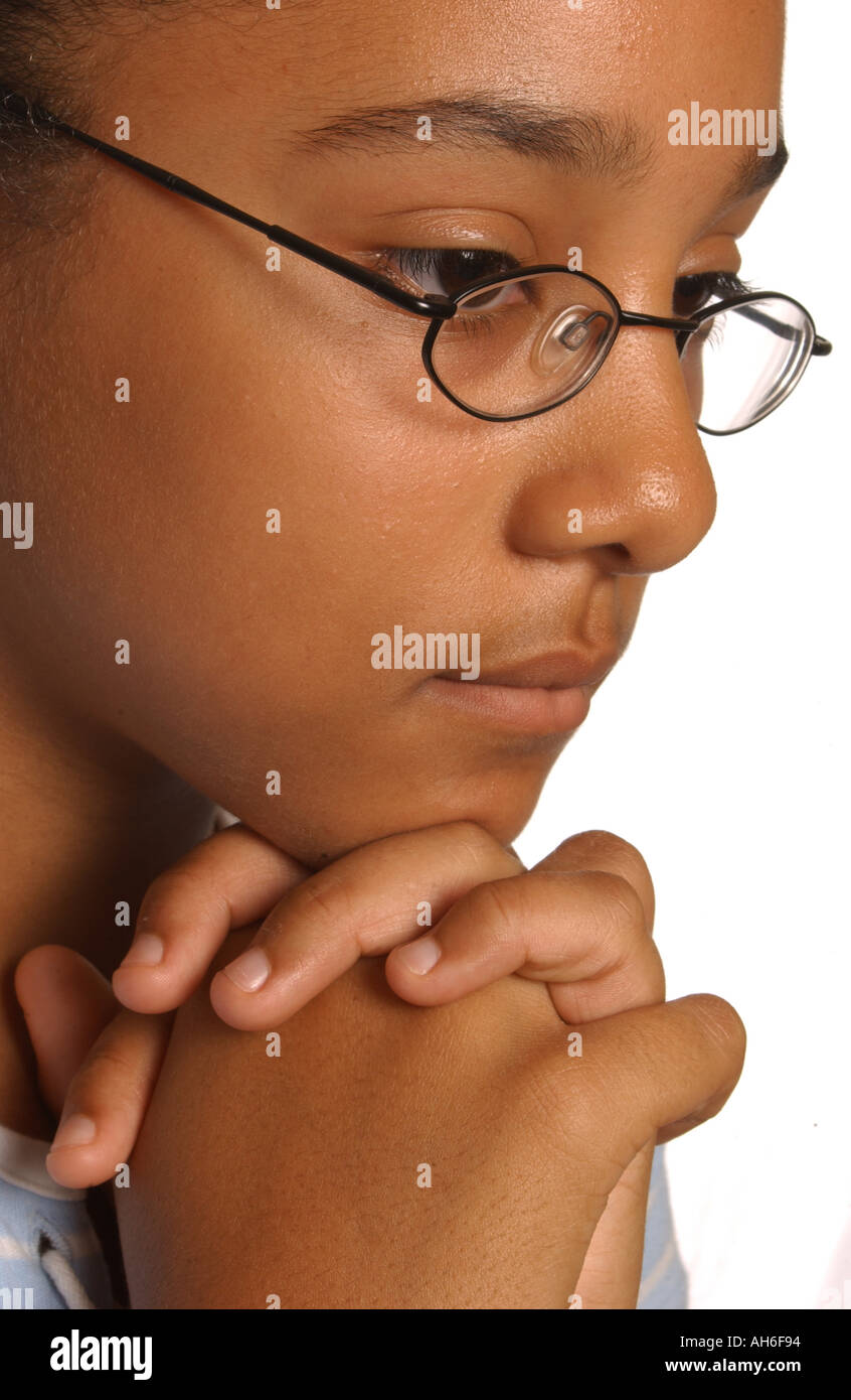 Young boy leaning his head on his hands thinking pensively Stock Photo ...