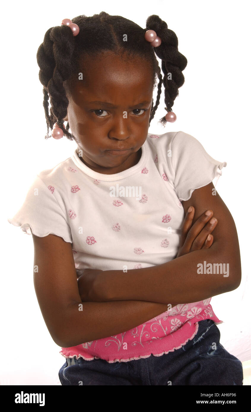 Young girl with arms crossed sulking Stock Photo - Alamy