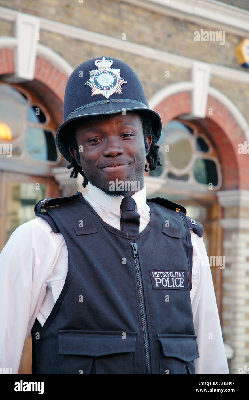 Young black policeman on beat in London Stock Photo - Alamy