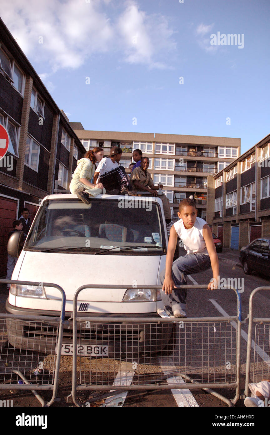 Lively group of children climbing and jumping on van parked on their ...