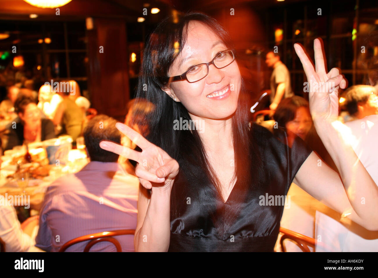 Woman Making Peace Sign with Hands Stock Photo - Alamy