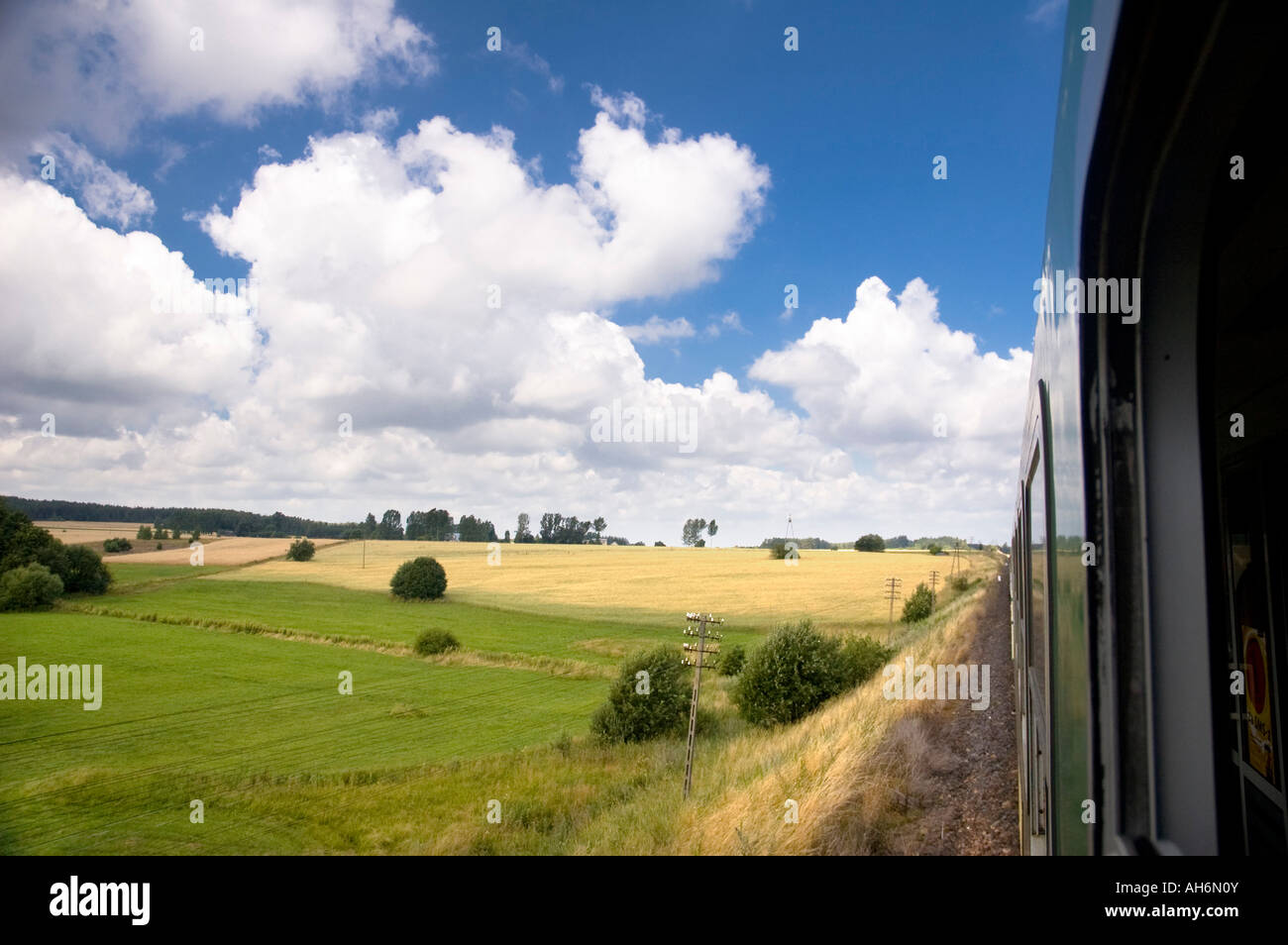 view out of the window of a running train on fields Eastern Poland ...