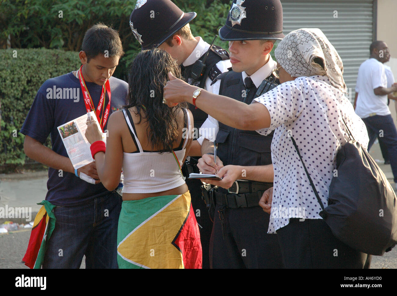 Young people asking directions to police officers Stock Photo - Alamy