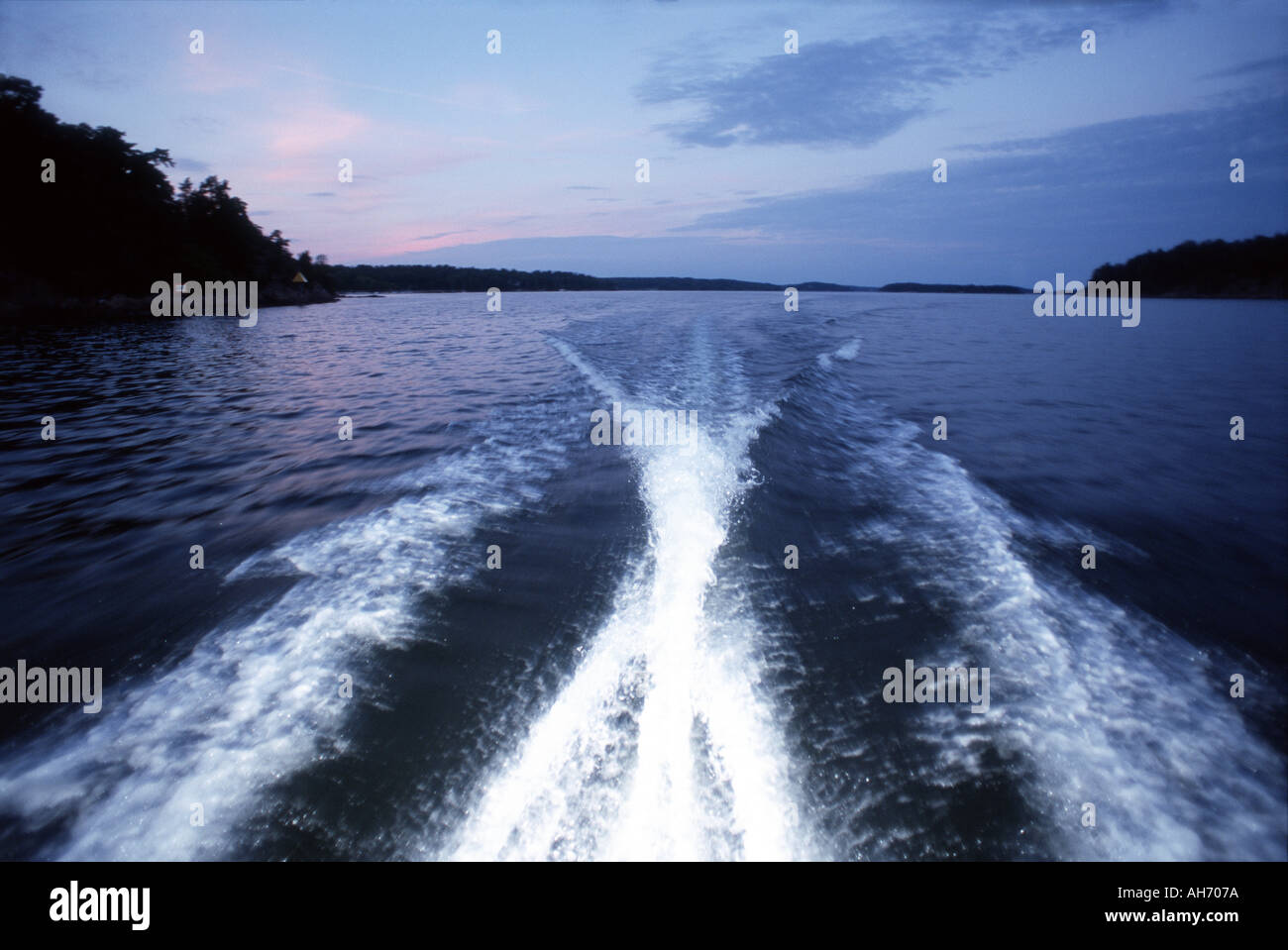 Wake of boat showing sea and Islands in evening light Stock Photo - Alamy