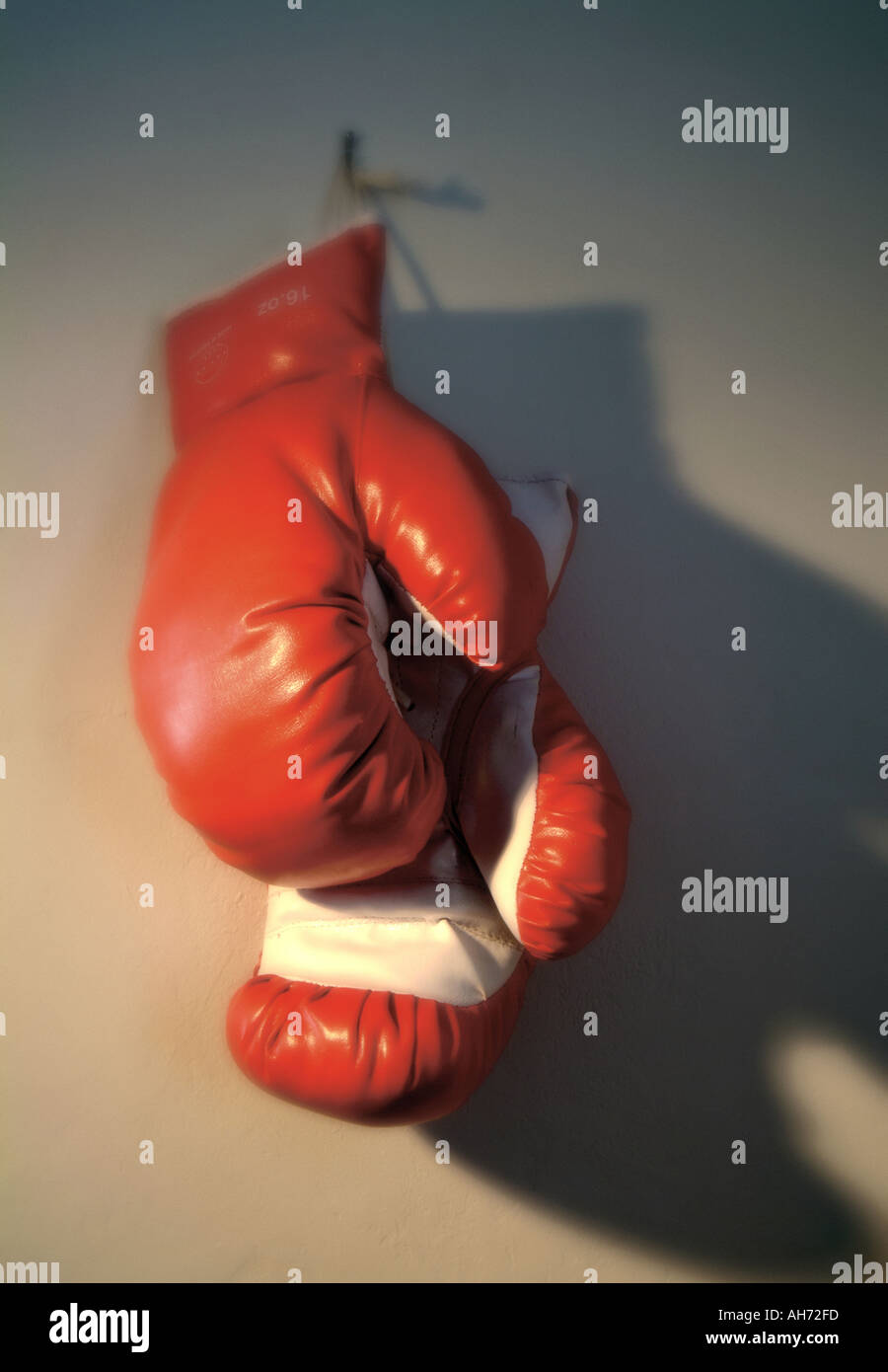 Red boxing Gloves hang on a wall Stock Photo - Alamy