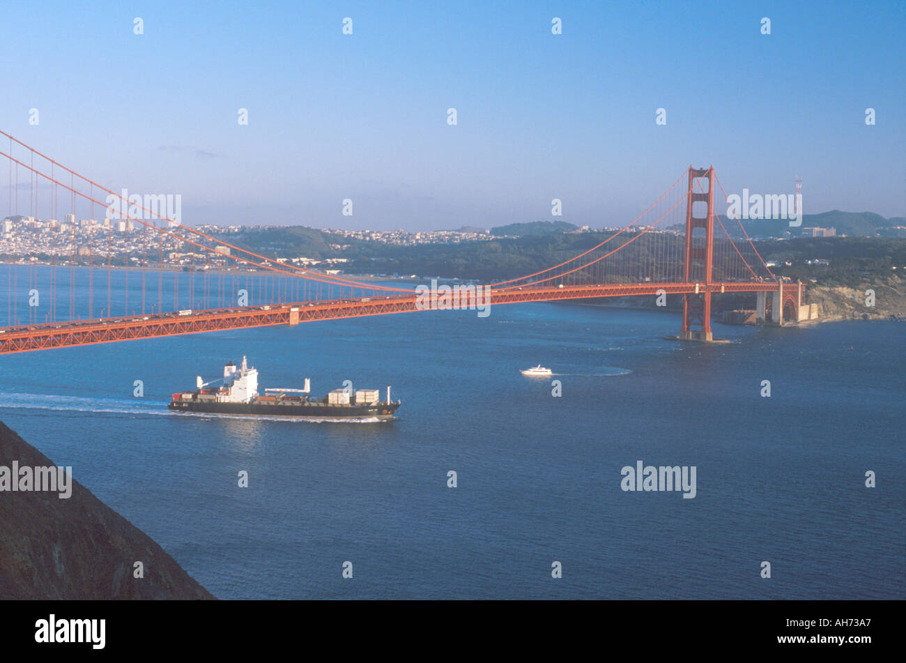 Container ship passing under golden gate bridge hi-res stock ...