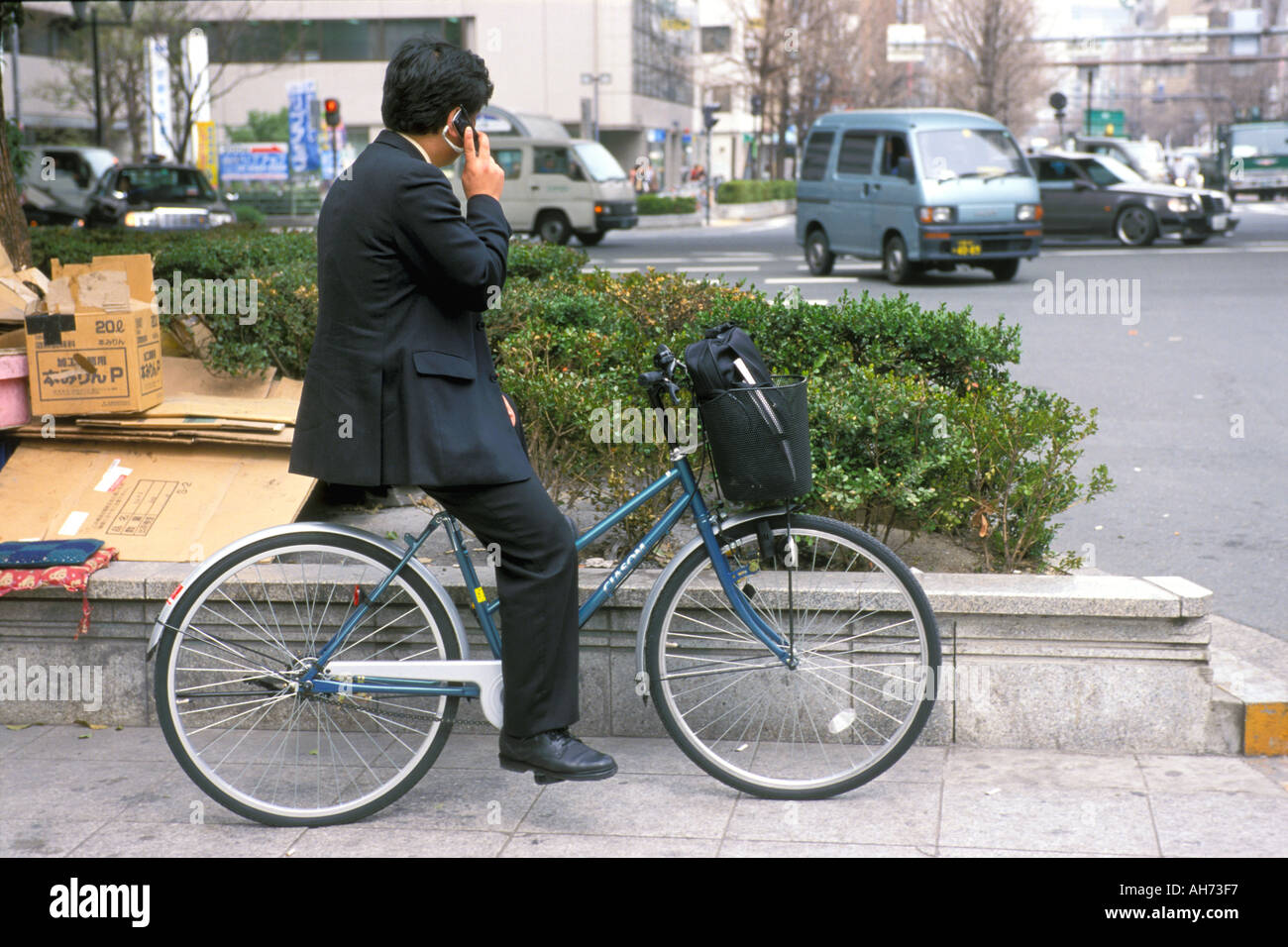 Japanese "sarariman" businessman wearing a suit talking on his mobile ...