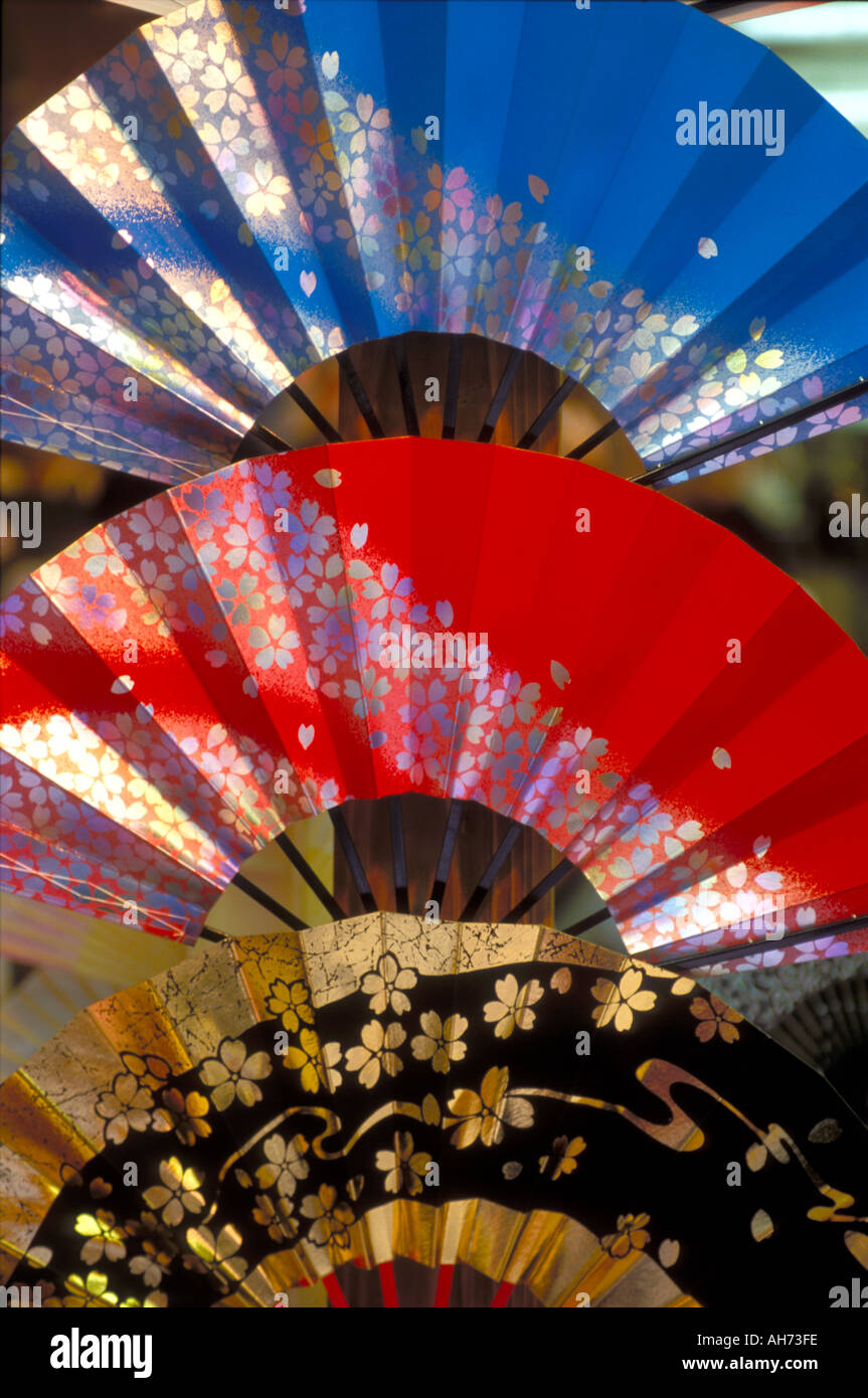 Blue, red and gold sensu folding fans with silver highlights on display ...