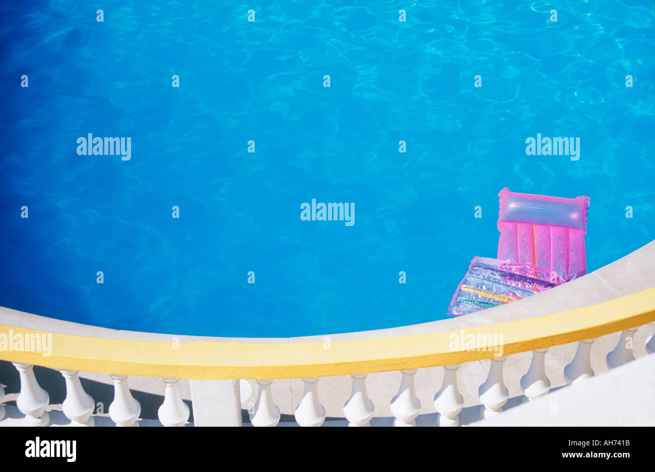 Swimming pool lilo and balustrade Stock Photo - Alamy