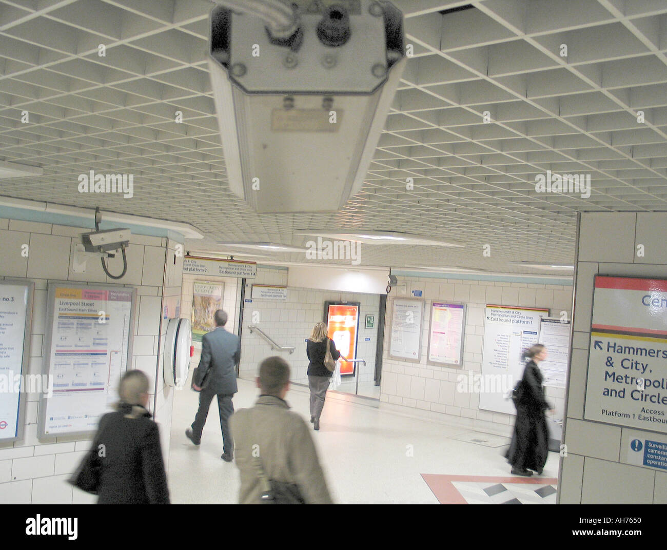 Cctv camera on the London underground with people passing by Stock ...