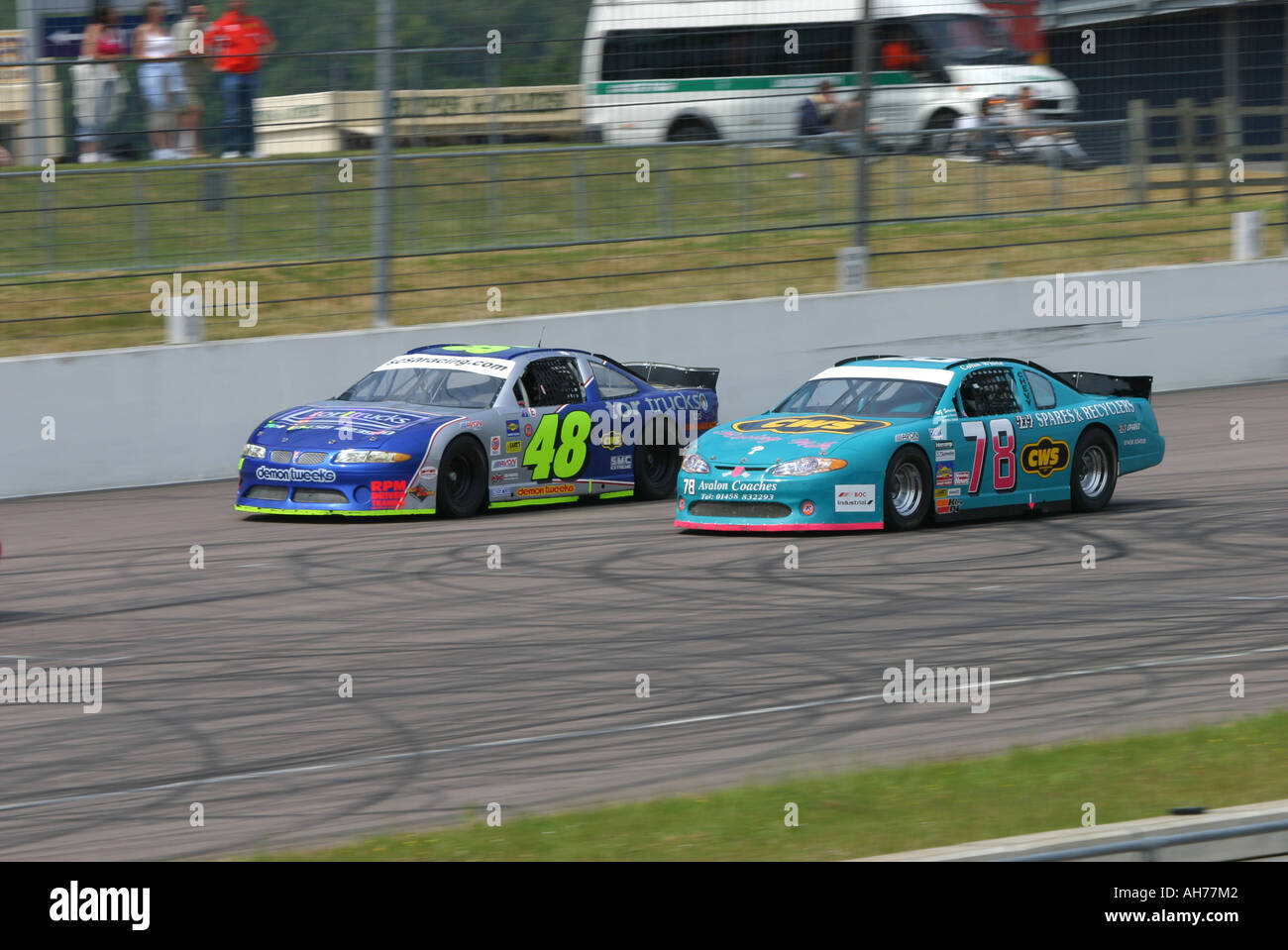 V8 Nascar type stock cars racing on a banked oval circuit Stock Photo ...