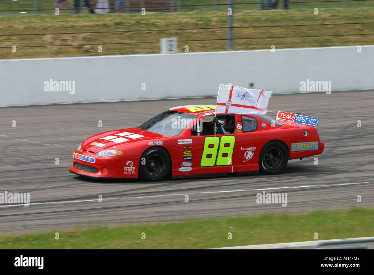 V8 Nascar type stock cars racing on a banked oval circuit Stock Photo ...