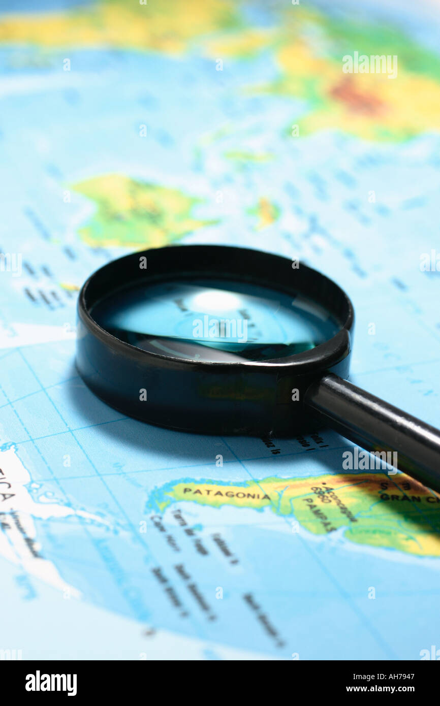 Magnifying Glass and Atlas Stock Photo - Alamy