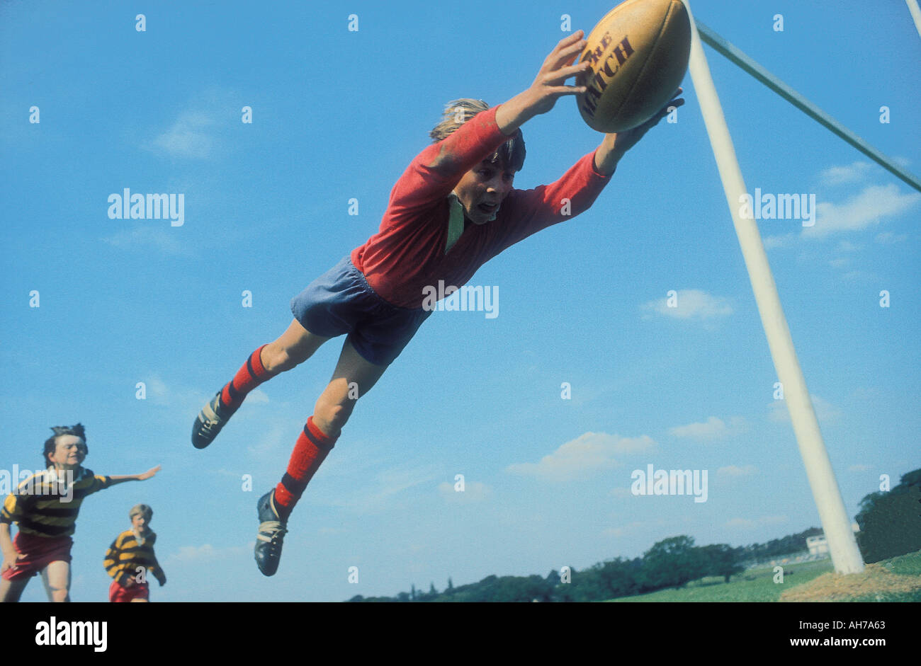 Young rugby player scoring a try with opponents in pursuit Stock Photo ...
