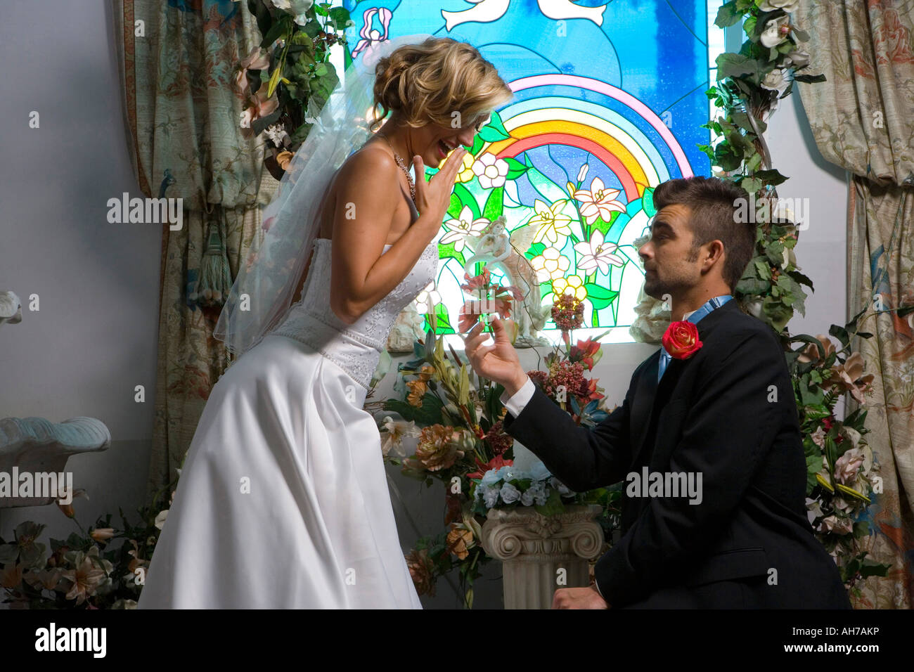 Bride and groom in front of a stained glass window Stock Photo - Alamy