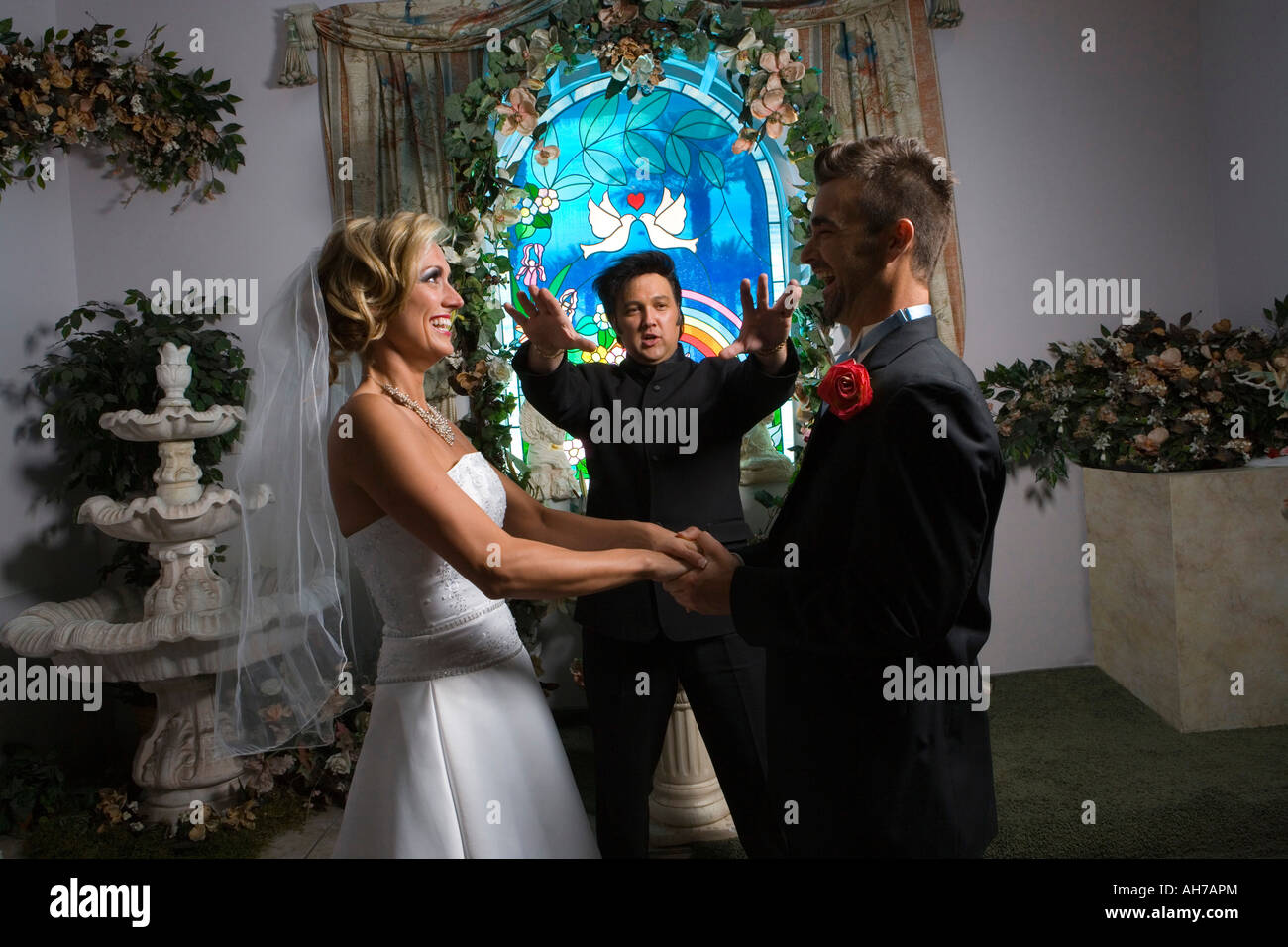 Bride and groom standing in front of a priest Stock Photo - Alamy