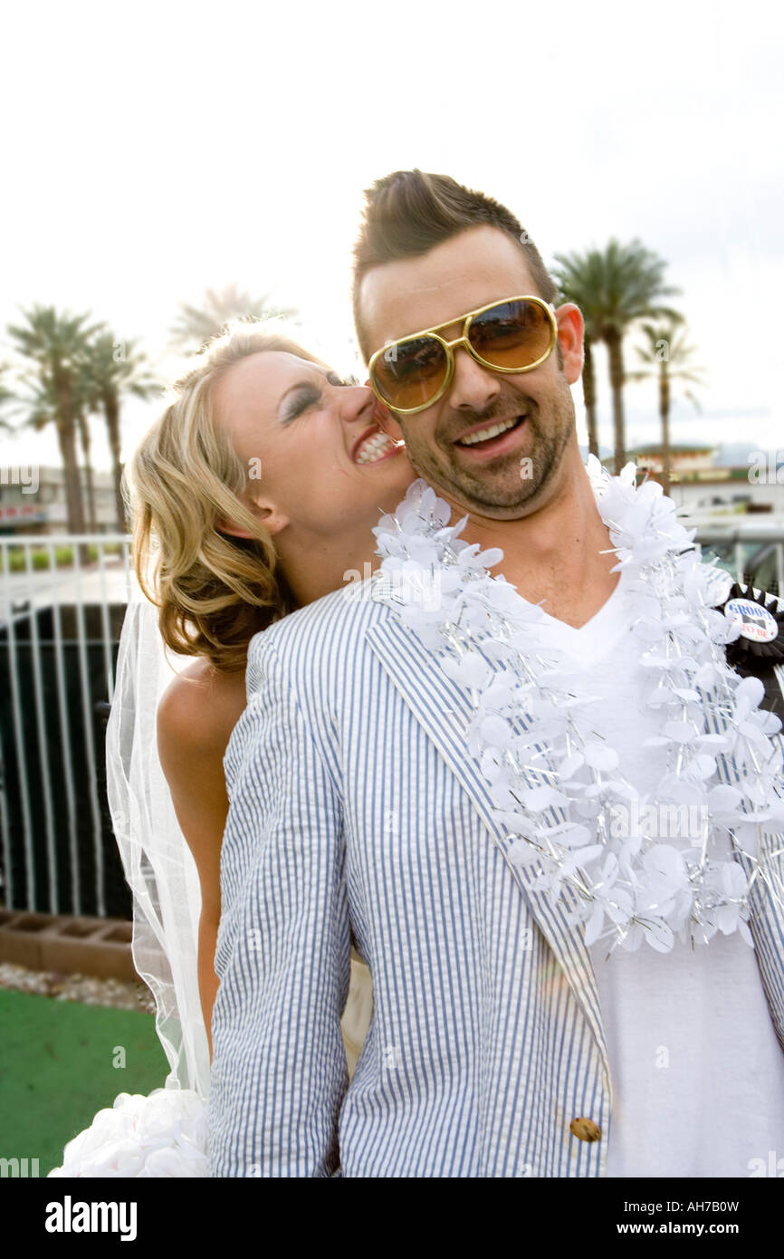 Bride biting a groom on the ear Stock Photo - Alamy