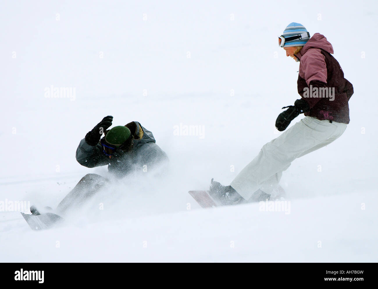 Mid adult couple snowboarding Stock Photo - Alamy