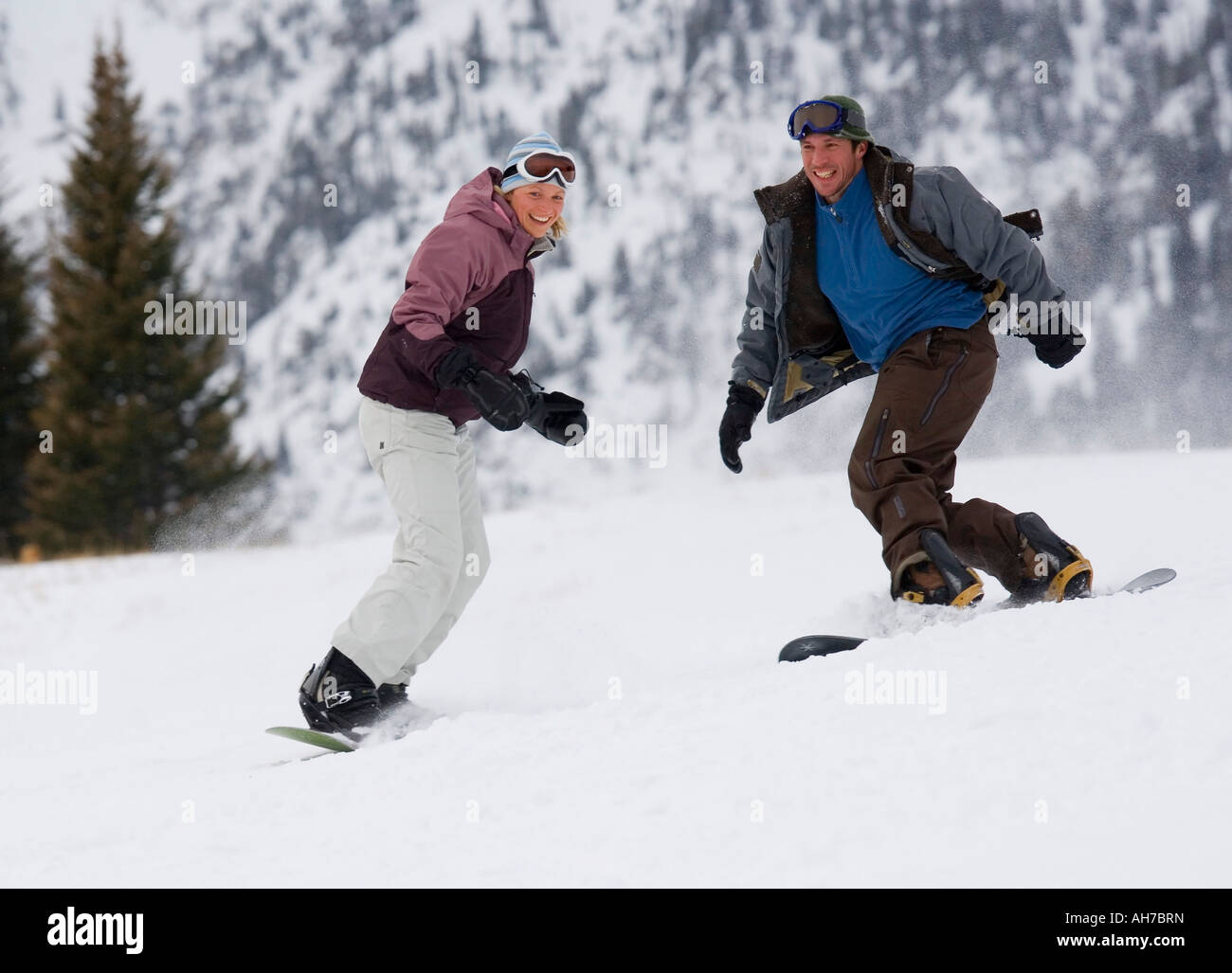 Mid adult couple snowboarding Stock Photo - Alamy