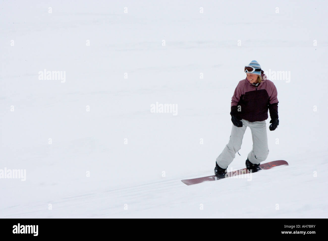 Mid adult woman snowboarding Stock Photo - Alamy