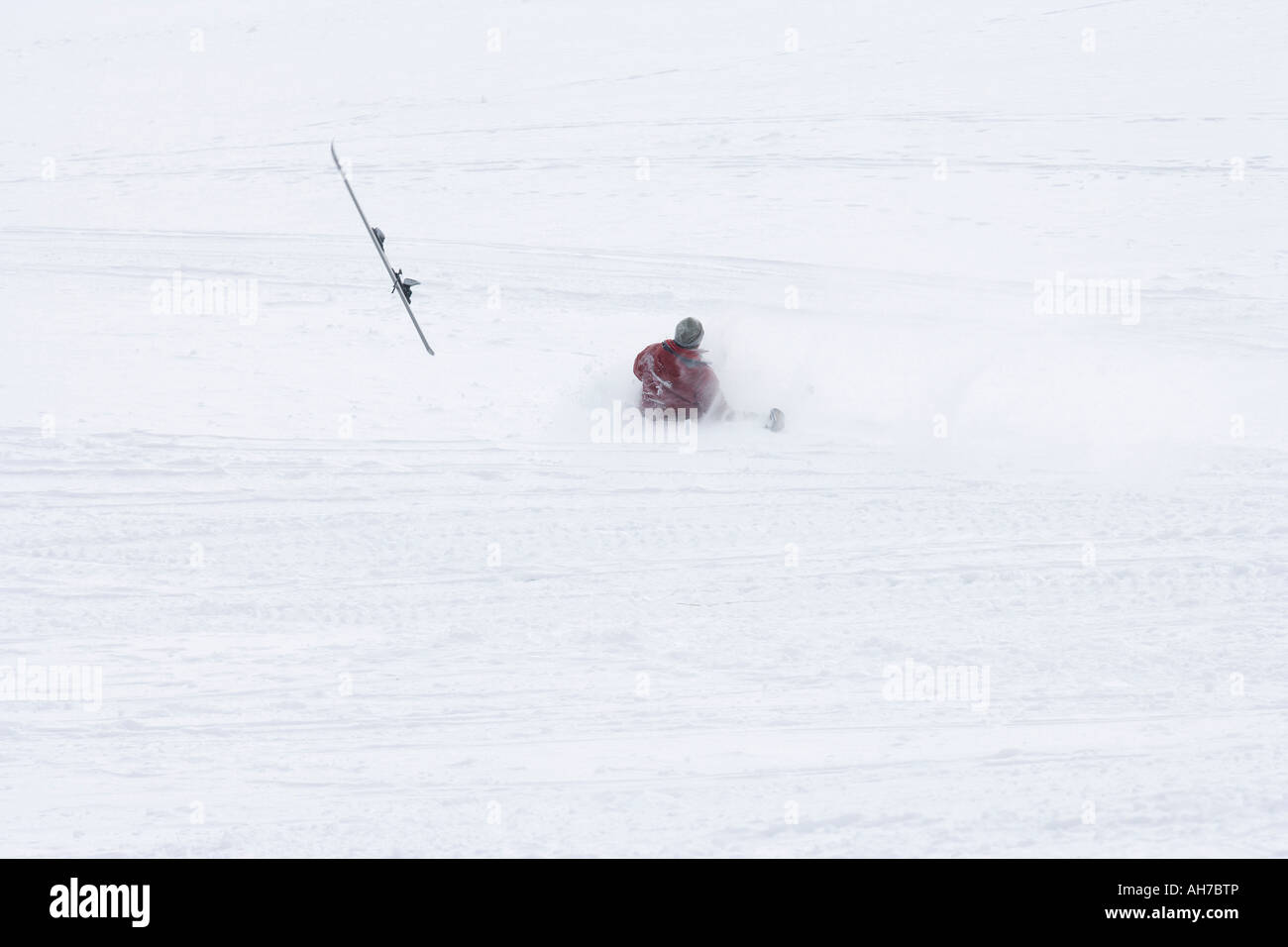 Man sliding downhill on snow Stock Photo - Alamy