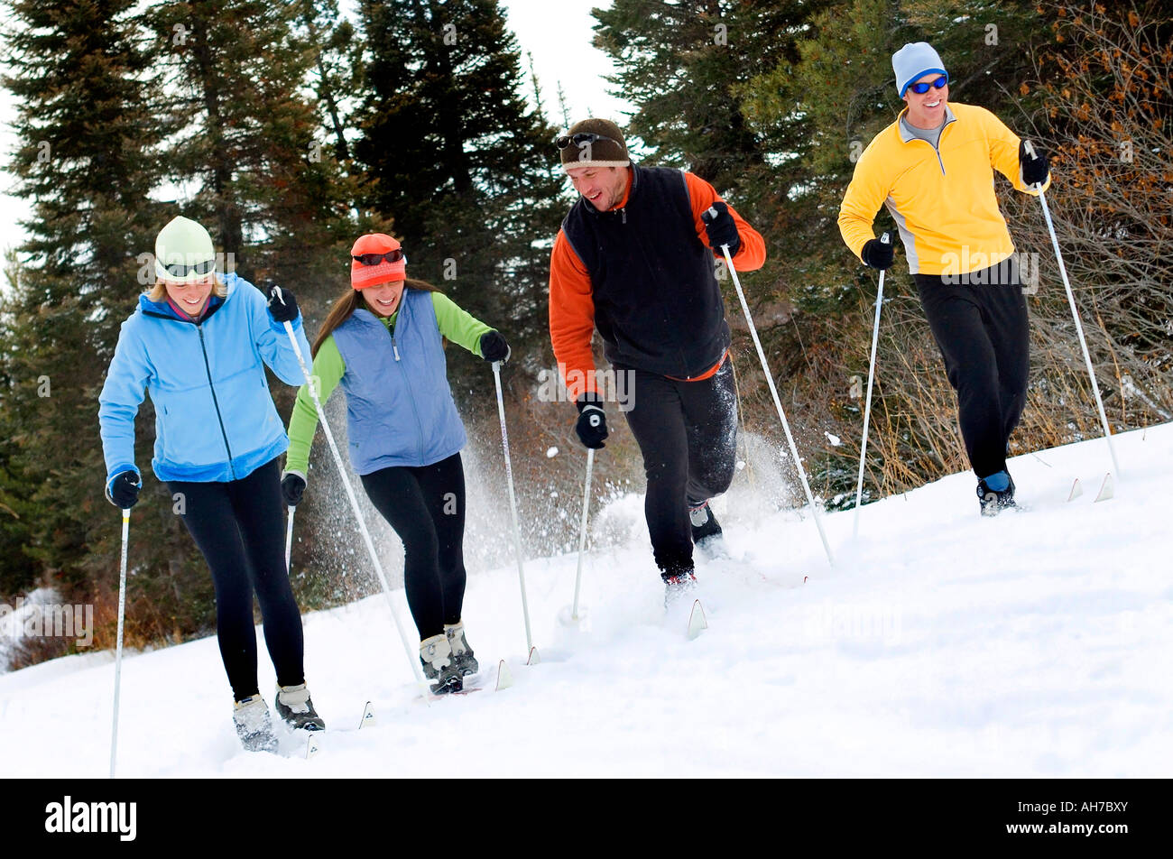 Four people skiing Stock Photo - Alamy