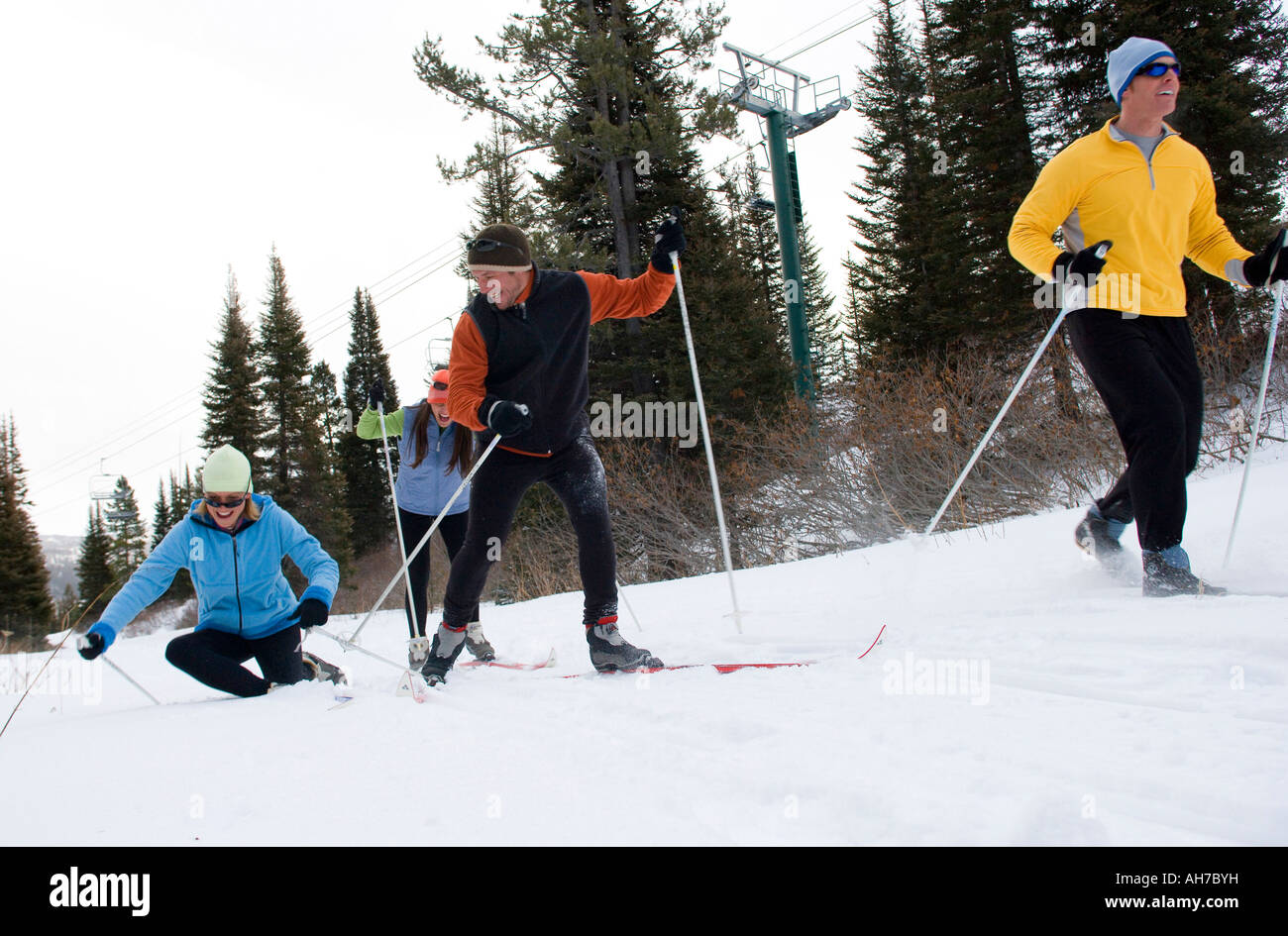 Three people skiing and one person falling Stock Photo - Alamy