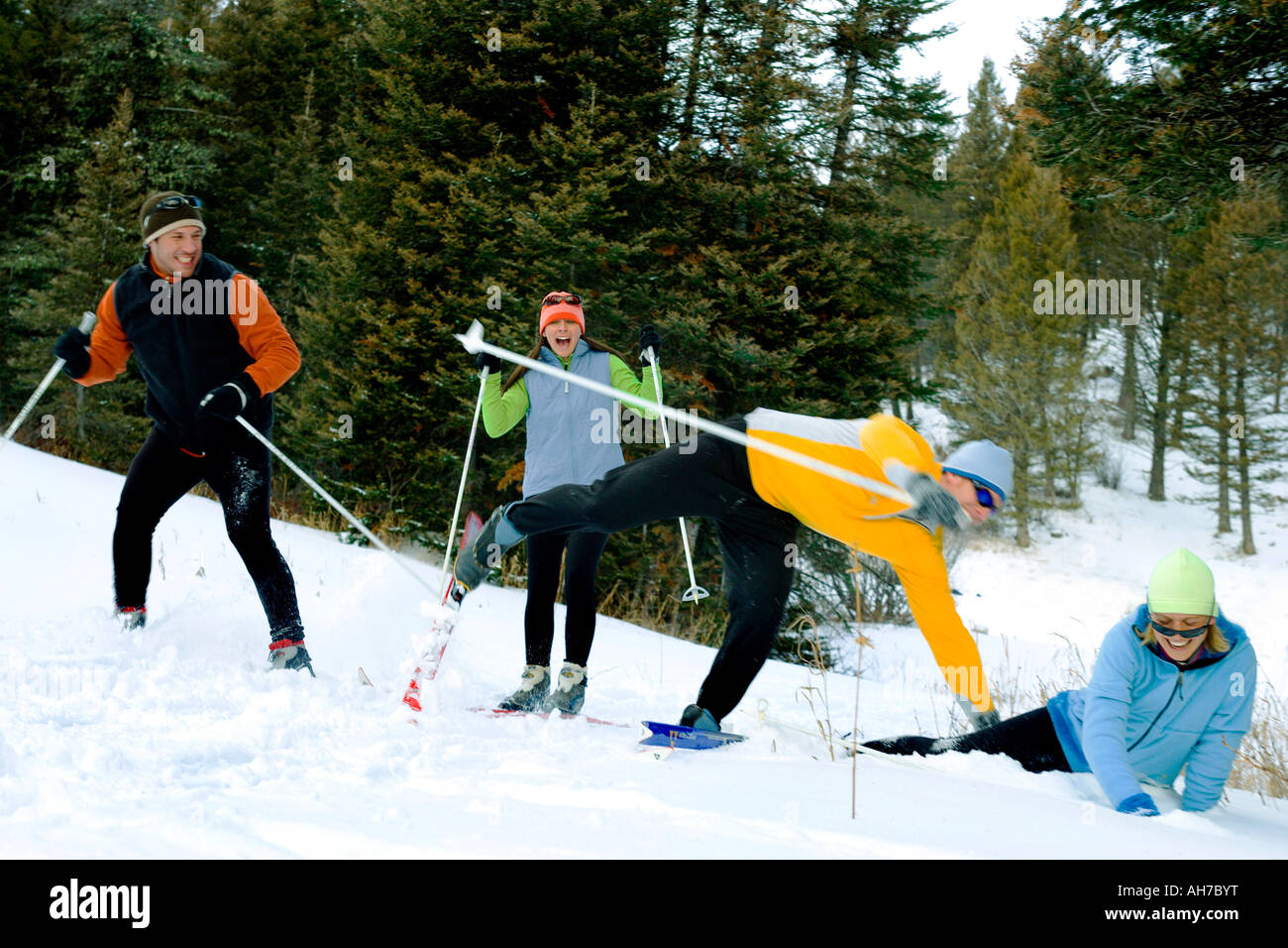 Two people skiing and two people falling Stock Photo - Alamy