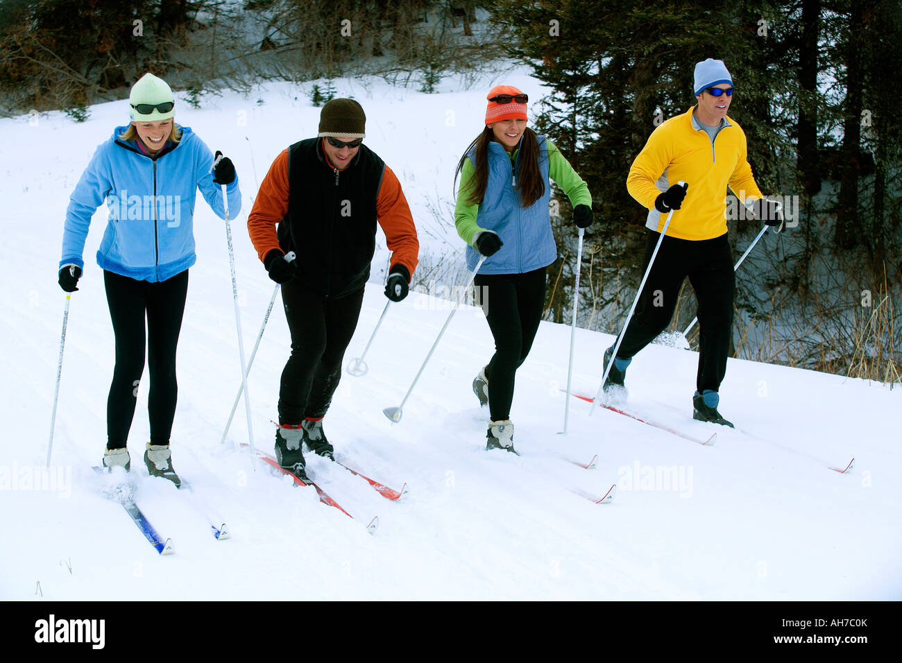Four people skiing Stock Photo - Alamy