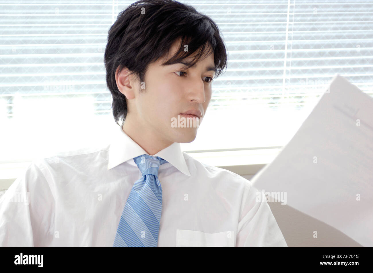 A office worker reading news paper Stock Photo - Alamy