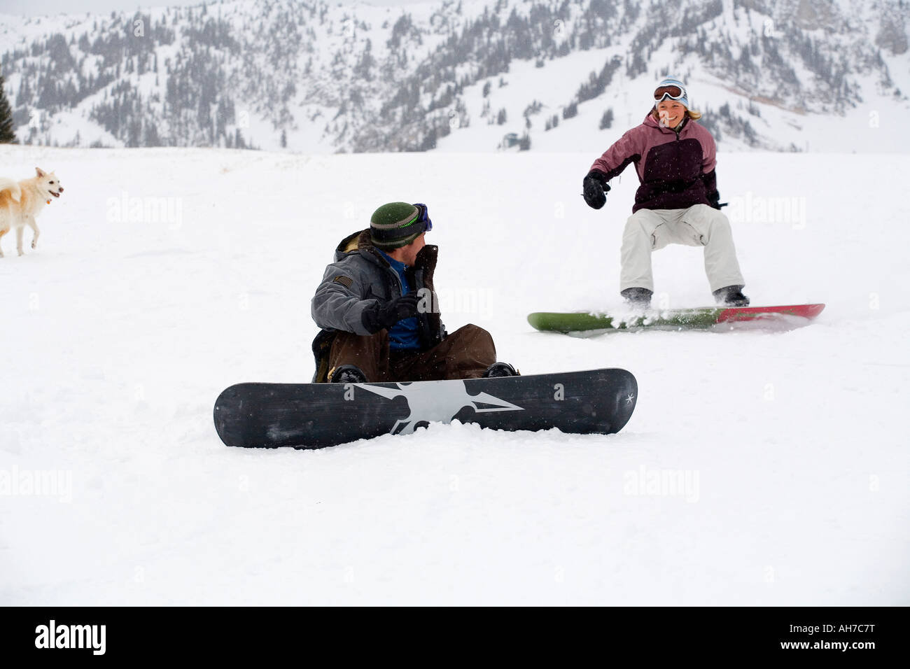 Mid adult couple snowboarding Stock Photo - Alamy