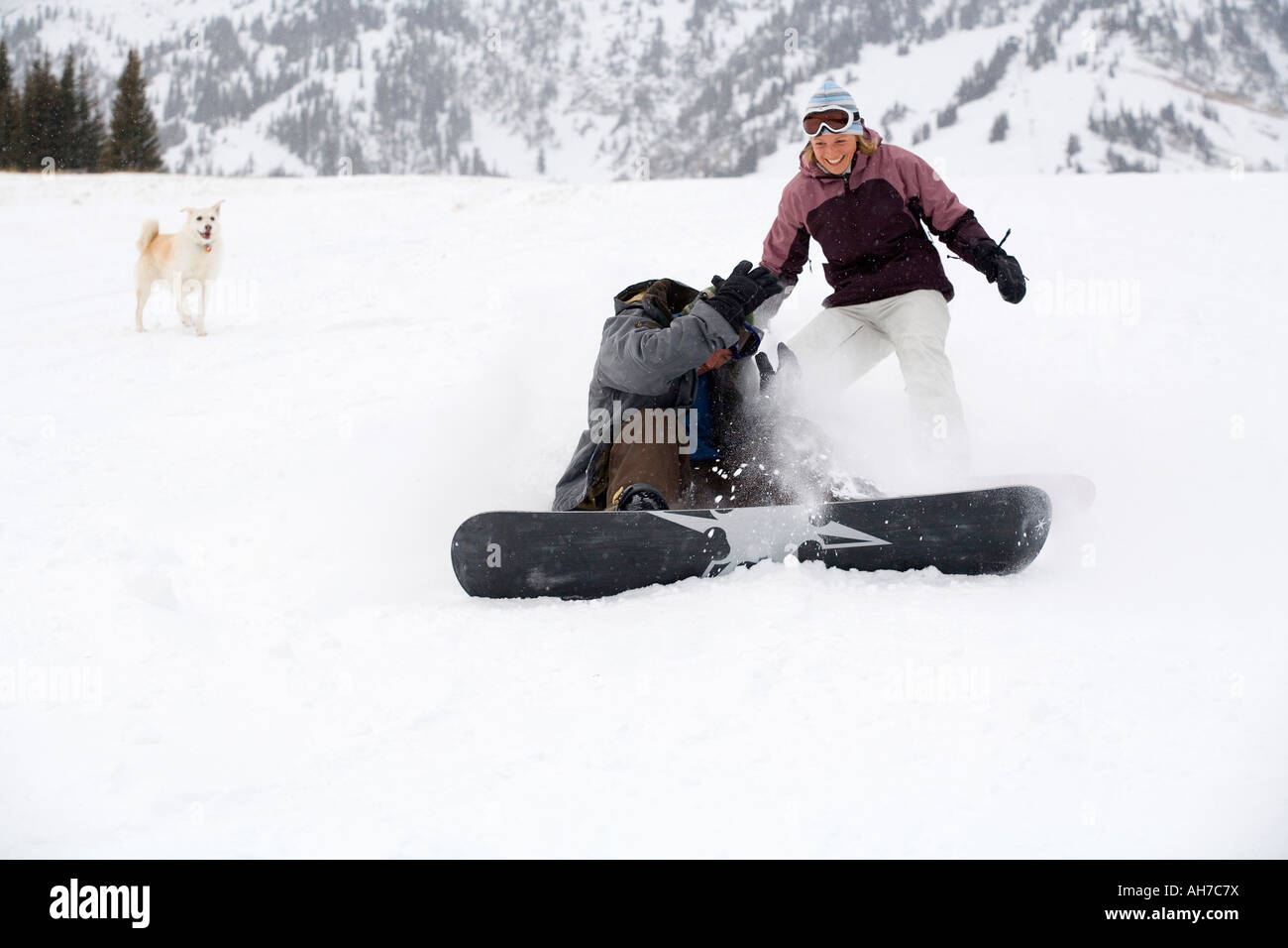 Mid adult couple snowboarding Stock Photo - Alamy