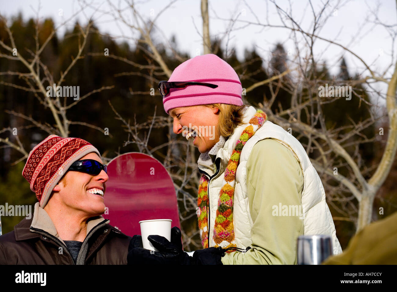 Mid adult woman giving a disposable cup to a young man Stock Photo - Alamy