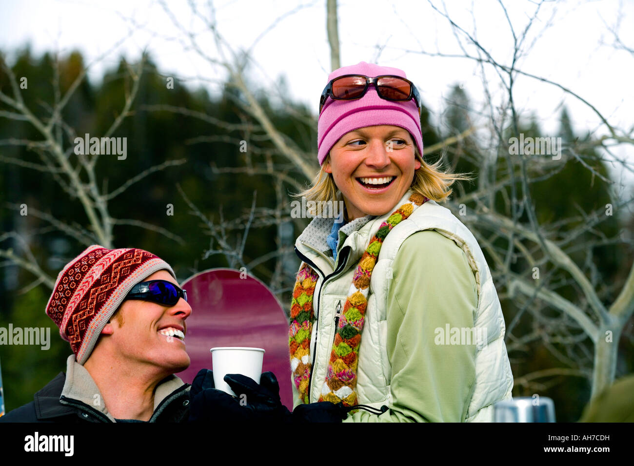 Mid adult woman giving a disposable cup to a young man Stock Photo - Alamy