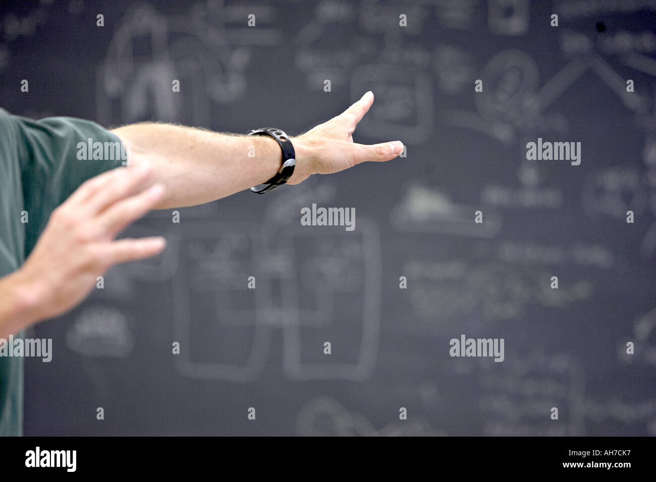 Male Science professor presenting information at blackboard edification ...