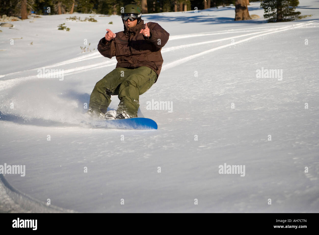 Mid adult man snowboarding Stock Photo - Alamy
