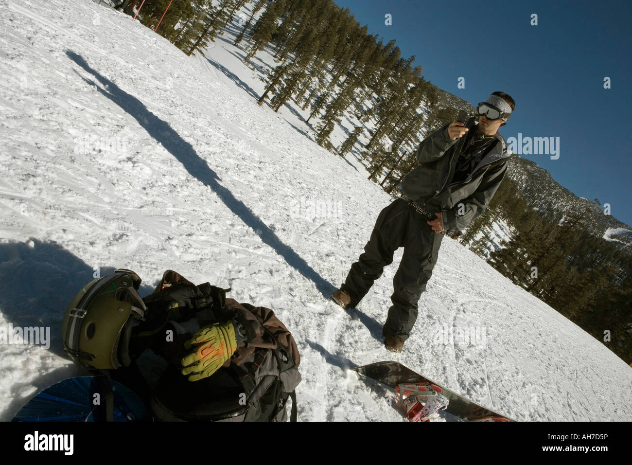 Young man standing and operating a mobile phone Stock Photo - Alamy