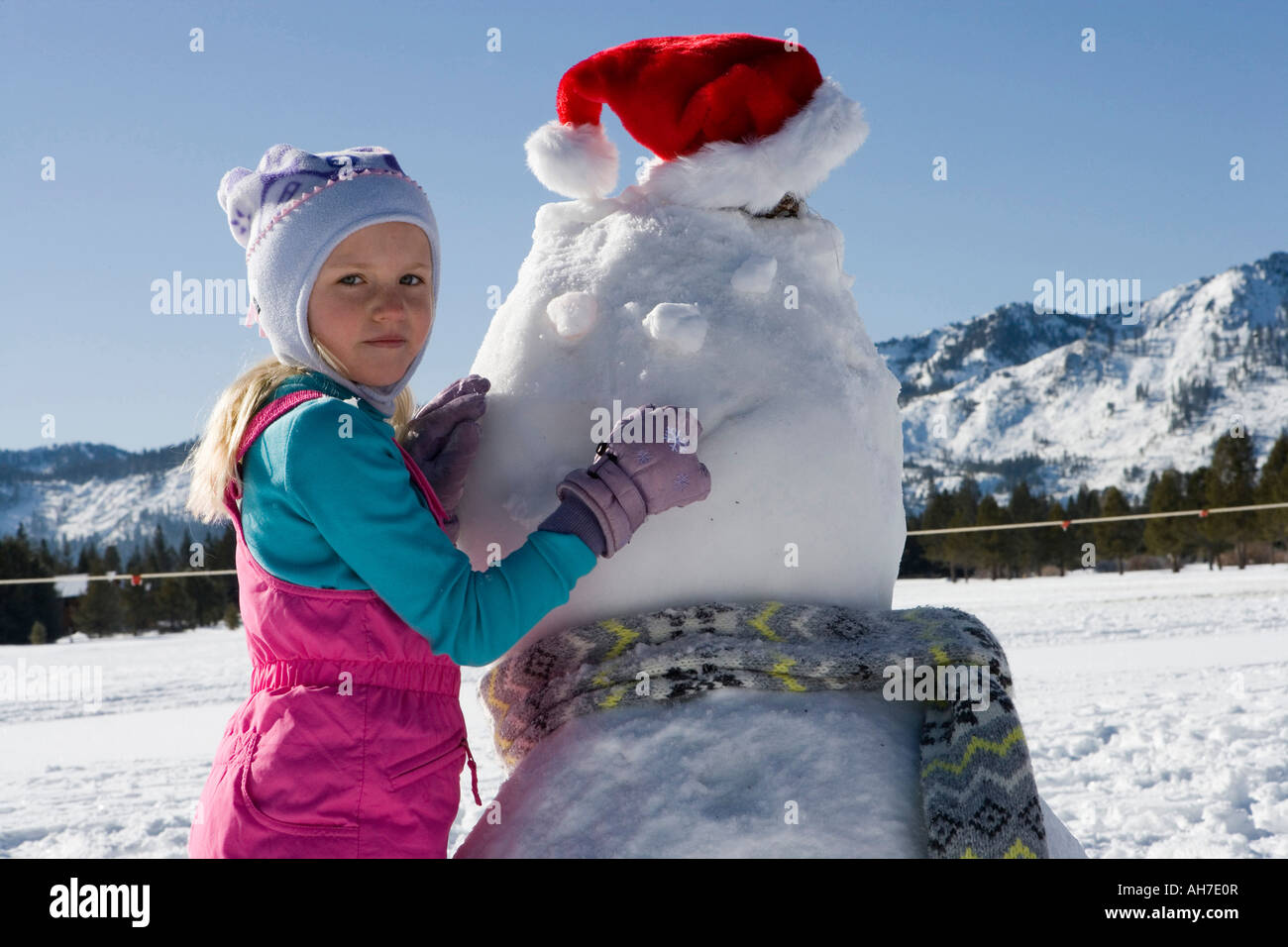 Child building snowman hi-res stock photography and images - Alamy