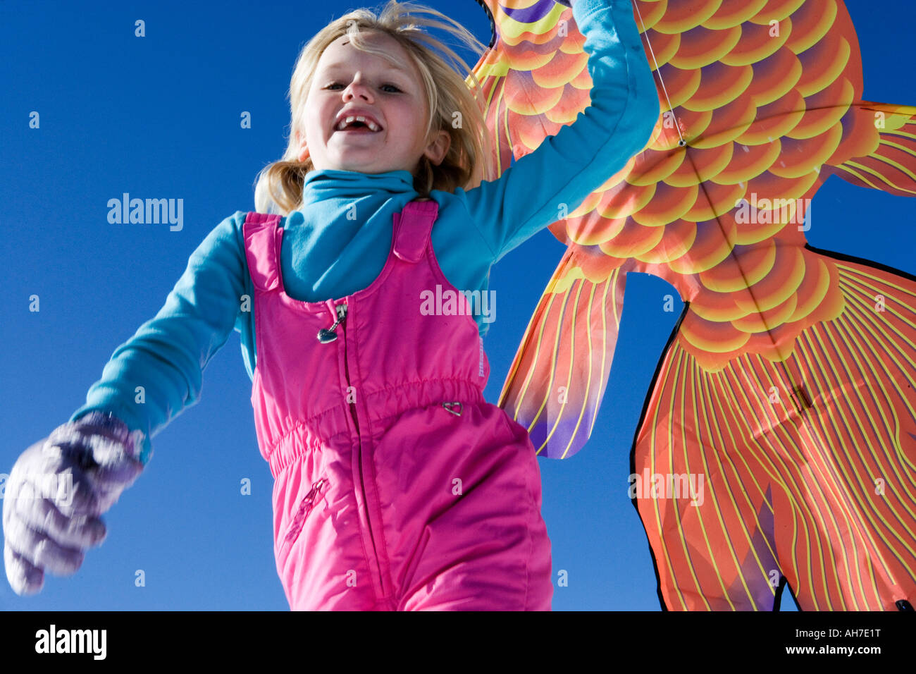 Low angle view of a girl running with a kite Stock Photo - Alamy